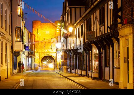 Night falls on High Petergate in York city centre, Bootham Bar in the ...