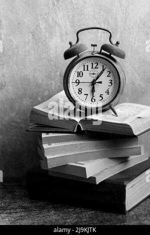 Still life with vintage mechanical alarm clock. Retro objects on grey ...