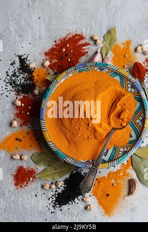 Turmeric powder on blue background toned in violet, Close-up Stock ...