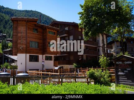 View of the main city center of Zermatt with old historic buildings ...
