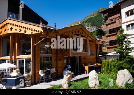View of the main city center of Zermatt with old historic buildings ...