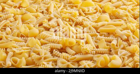 Variety of raw pasta types, farfalle bow-tie, fettuccine or tagliatelle ...