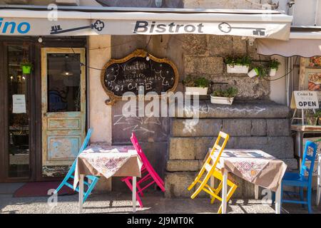 Bistro with table / tables and chairs propped forward during the ...