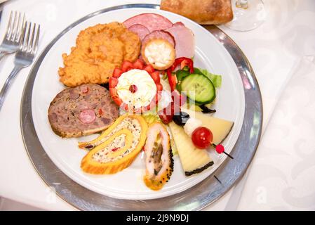 typical plate of Romanian appetizers that have stuffed tomato, cucumber ...