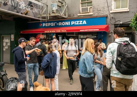Passerby and the curious congregate in front of the Pepsi Cola Co.one ...