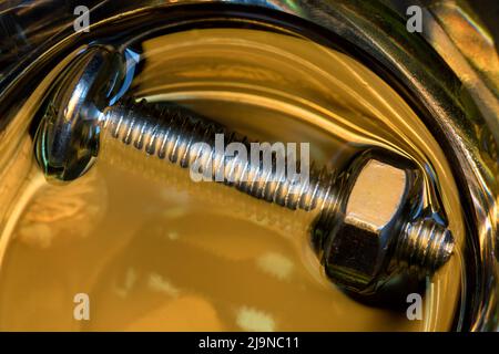 Metallic nuts and bolts in lubrication oil Stock Photo - Alamy
