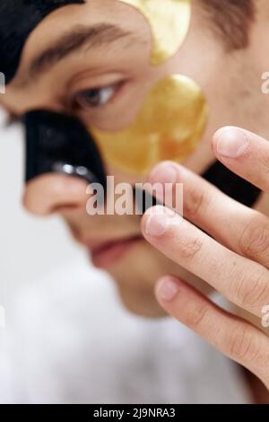 handsome guy many patches on the face touches face with hands skin care ...