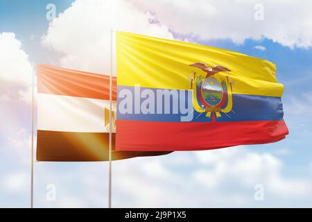 Ecuador and Egypt flags waving together on blue cloudy sky, two country ...
