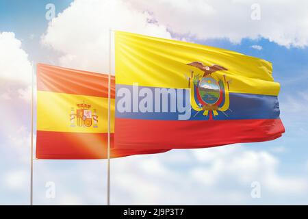 Spain and Ecuador flags waving together in the wind on blue cloudy sky ...