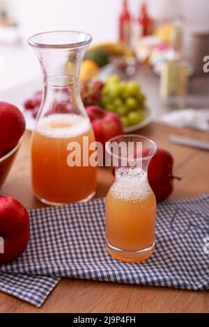 bottles of fruit juice and smoothie with fresh fruits on wooden table ...