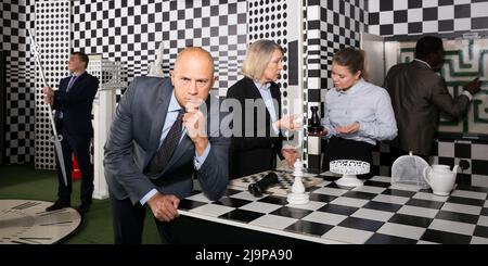 Confused man in escape room Stock Photo - Alamy