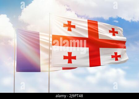 Georgia and France flags waving together on blue cloudy sky, two ...