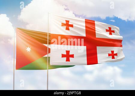Georgia and Jordan flags waving together on blue cloudy sky, two ...