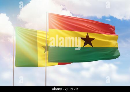 Ghana and Senegal flags waving together on blue cloudy sky, two country ...