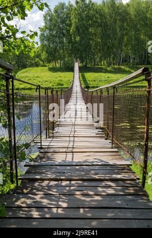 Hanging bridge goes over river Stock Photo - Alamy