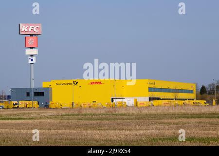 A yellow parcel station of the German parcel service DHL in front of a ...