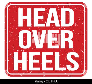 HEAD OVER HEELS text written on green-black grungy stamp sign Stock ...