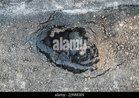 Asphalt swelling close-up. Pothole and pit on road Stock Photo - Alamy