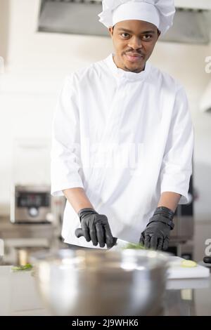 Young male cook working in the kitchen Stock Photo - Alamy