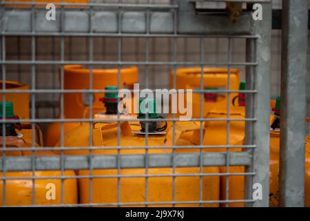Natural gas stored in metal bottles, orange in color Stock Photo - Alamy