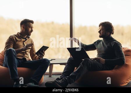 Business team discussing strategy at computers during office analytics ...