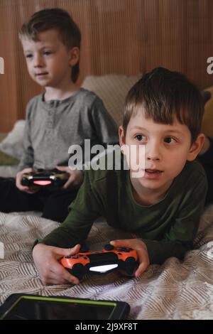 Kids playing console games using joystick Stock Photo - Alamy