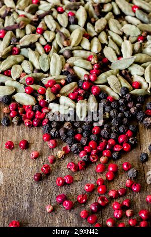 Pepper mix and cloves. Black, red and white peppercorns isolated on ...