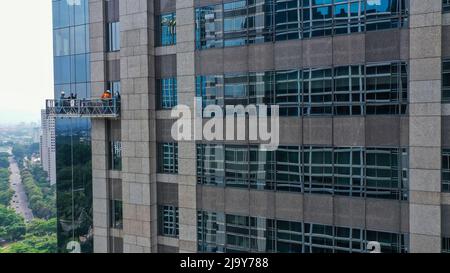 two workers are washing windows at a height. Professional cleaning ...