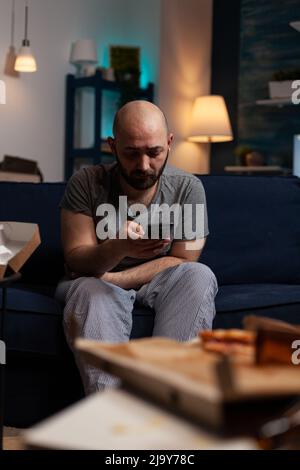 Depressed, worried man reading renter notification for unpaid bank ...