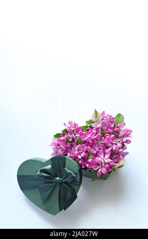 Blue gift box with flowers on pink fabric background holidays concept ...