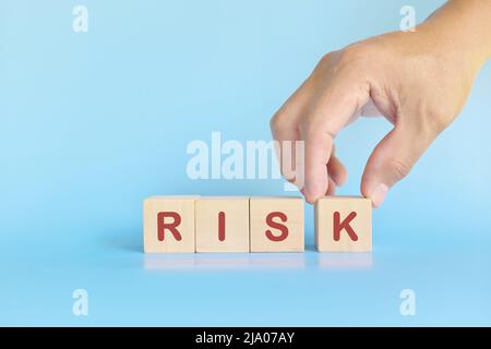 Hand building risk word in wooden blocks. Business risk management ...