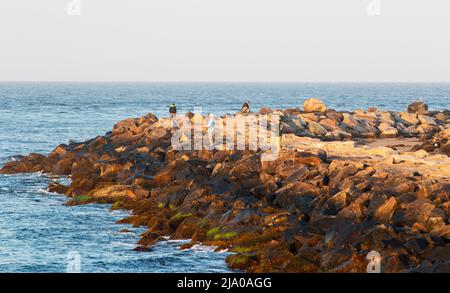 Rock jetty in Narragansett Rhode Island sticking out into the ocean ...