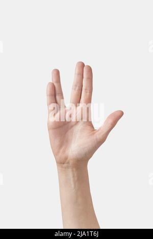 Funny alien hello gesture female hand on white Stock Photo - Alamy