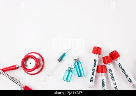 Monkeypox vaccine, syringe and stethoscope on yellow background ...
