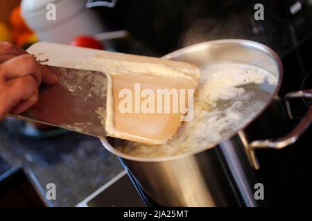 Swabian cuisine, preparing spaetzle for cheese spaetzle, hand-scraped ...
