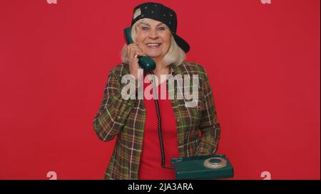 Hey you, call me back. Cheerful woman secretary in coat talking on ...