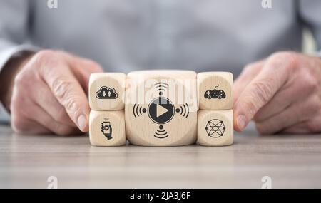 Wooden blocks with symbol of video streaming concept on blue background ...
