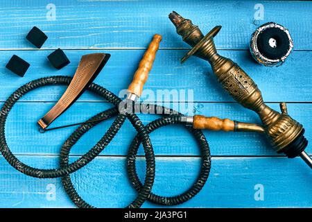 Parts of the hookah on blue wooden background. Hookah accessorie Stock ...