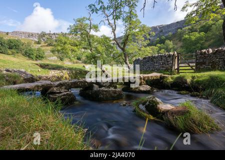 Improvised stone bridge over Malham Cove stream in the Yorkshire Dales ...