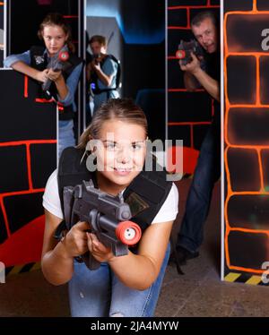 Portrait of positive man with laser gun having fun with her friends on ...