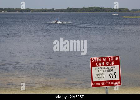 Warning sign at a Florida lake: Swim At Your Own Risk, Alligators and ...