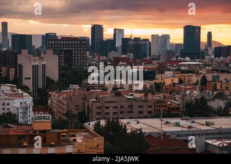 A dramatic and fiery sunset over the skyline of Mexico City, Mexico ...