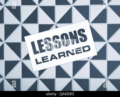 blank card with text Lessons learned on wooden background. Business ...
