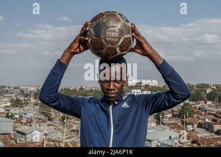Louis Otieno (Denilso) takes a posture carrying a metalic Fifa Soccer ...