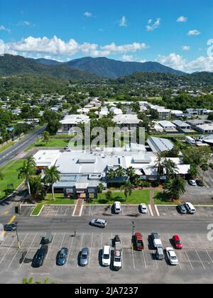 A vertical aerial view of beautiful mountain silhouettes under a bright ...