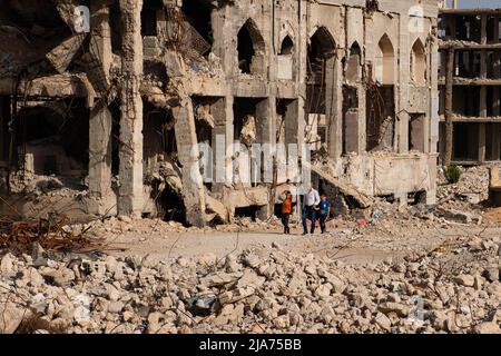 Darayya, Syria - April, 2022: A family walking through ruins in ...