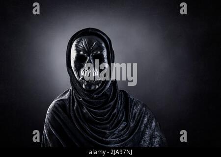 Grim reaper over dark misty background Stock Photo - Alamy