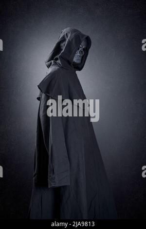 Grim reaper over dark misty background Stock Photo - Alamy
