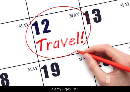 12th day of May. Hand drawing a red circle and writing the text ...