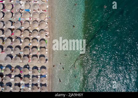 Aerial view of Budva Montenegro beach with sunshades and swimmers Stock ...
